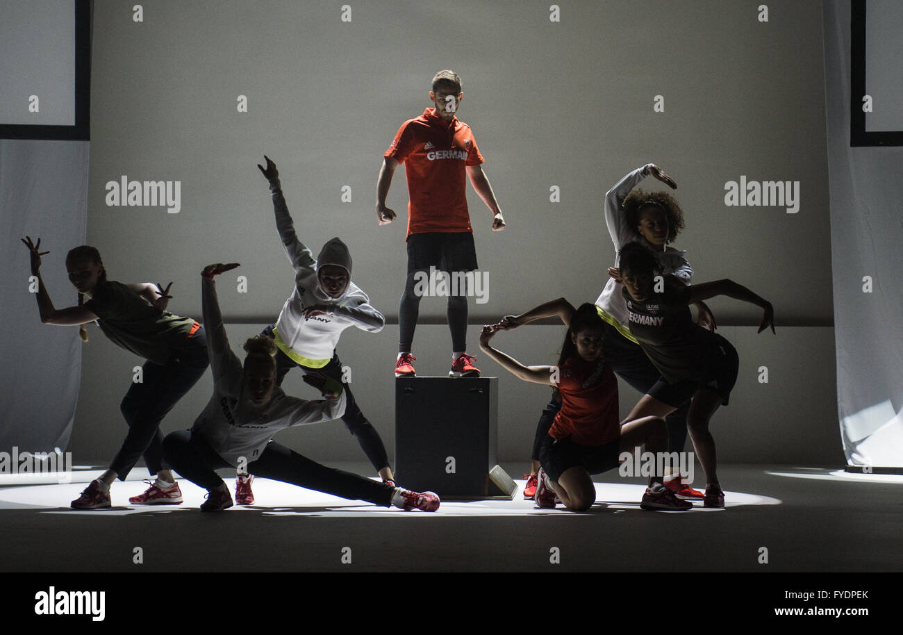 Athletes and models present outfits designed for the German Olympics ...
