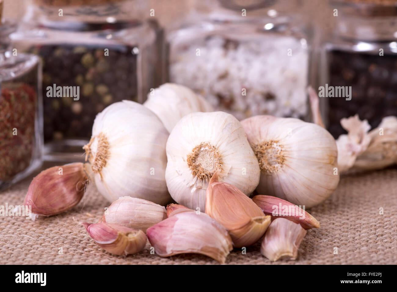image of fresh garlic surrounded by containers with herbs Stock Photo ...