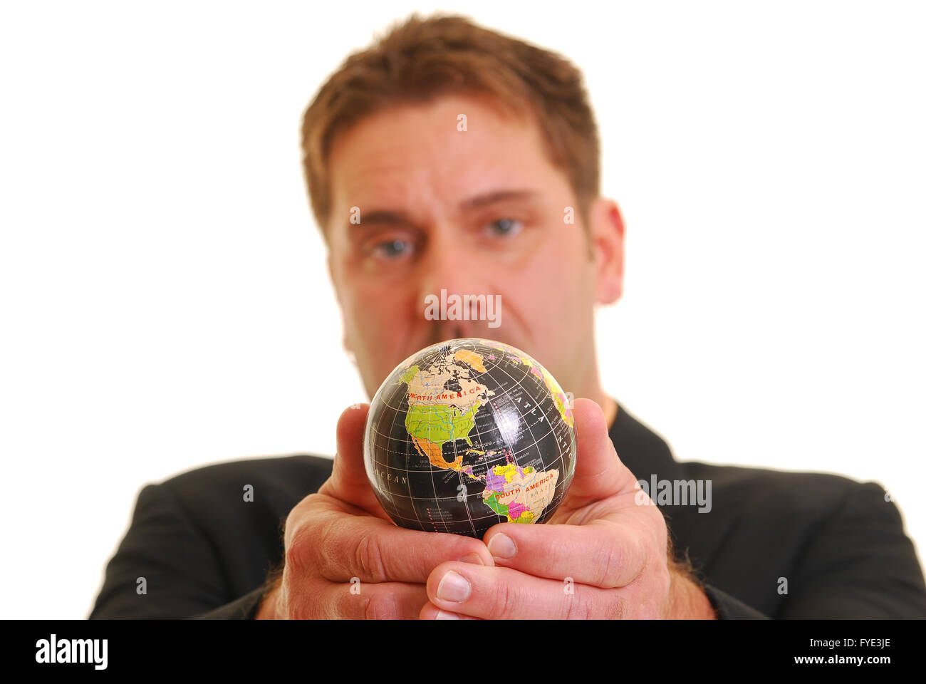 Man looking at globe Stock Photo - Alamy