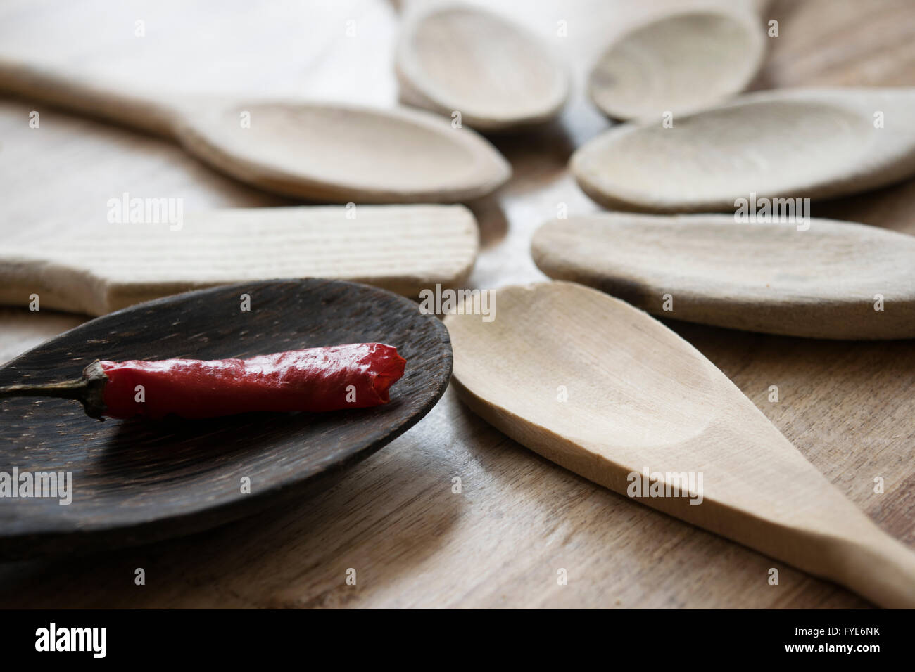 series of wooden spoons with a hot chilli Stock Photo - Alamy