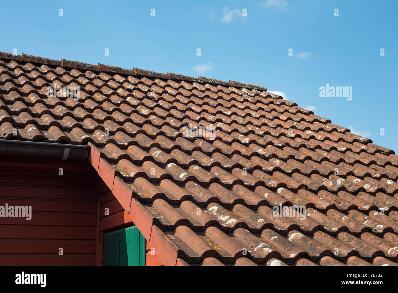Detail of roof tiles from a garden house on a sunny day with blue sky ...