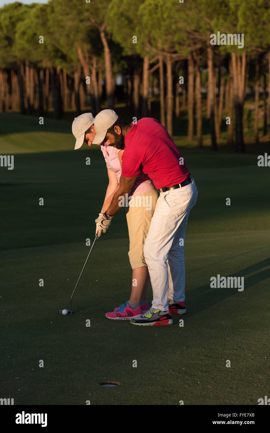 Male Golf Instructor Teaching Female Golf Player Personal Trainer Giving Lesson On Golf Course