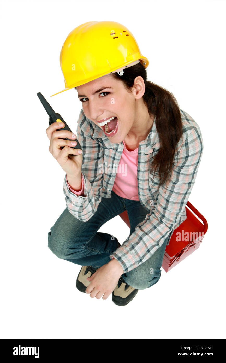 Female construction worker yelling into a walkie-t Stock Photo - Alamy