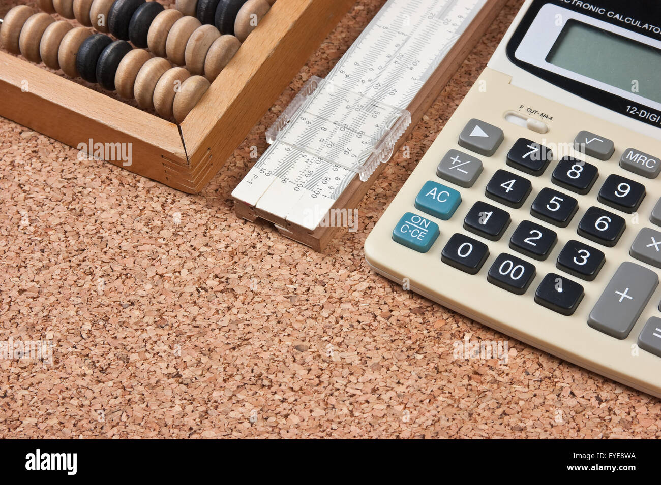 calculator, wooden abacus and slide rule on a cork board Stock Photo ...