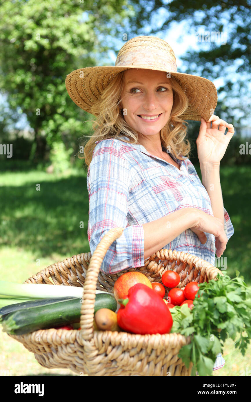 Woman with a straw hat and basket of vegetables Stock Photo - Alamy