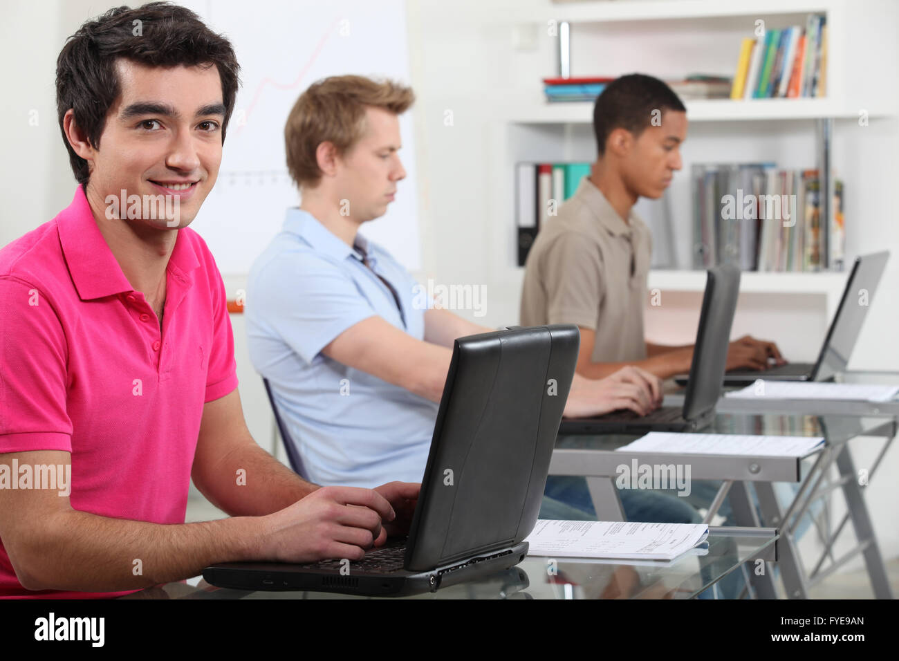 Young men working on their assignments in a computer lab Stock Photo ...