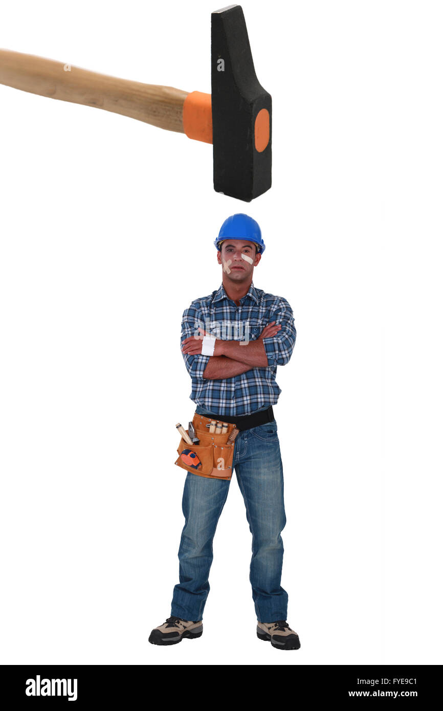 Injured laborer with big hammer over the head Stock Photo - Alamy