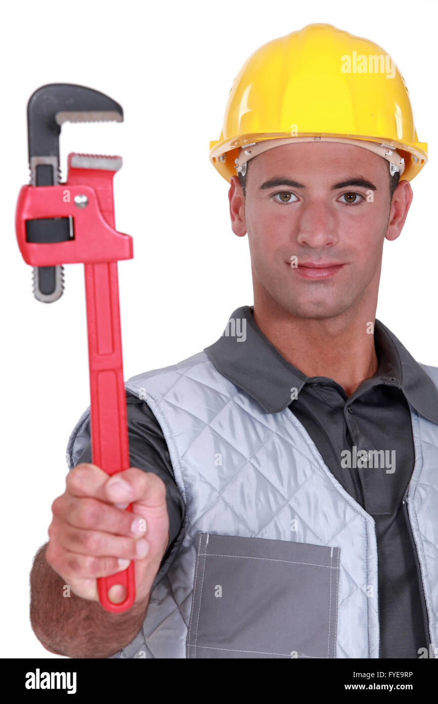 Man with a heavy duty adjustable pipe wrench Stock Photo - Alamy