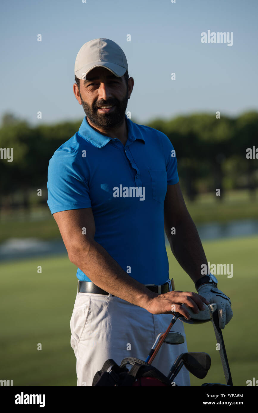 handsome middle eastern golfer portrait at golf course at sunny day ...
