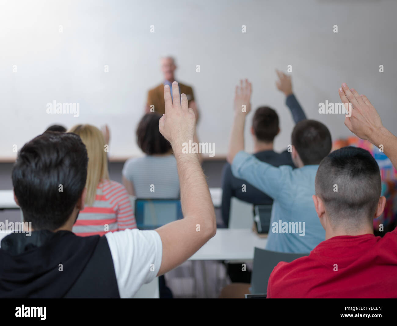 senior teacher teaching lessons, smart students group raise hands up in ...