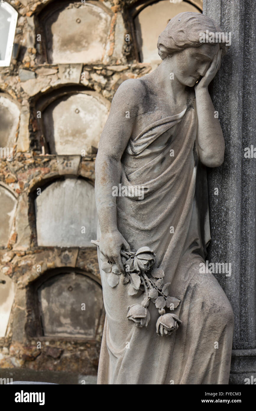 Statue of a classical woman with roses in the hand regretting the loss ...