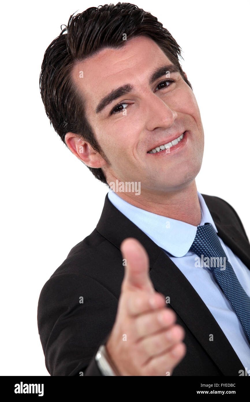 Businessman holding his hand out for a handshake Stock Photo - Alamy