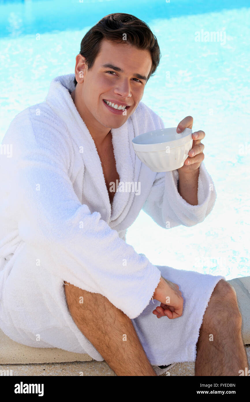 young guy having coffee at edge of swimming-pool Stock Photo - Alamy