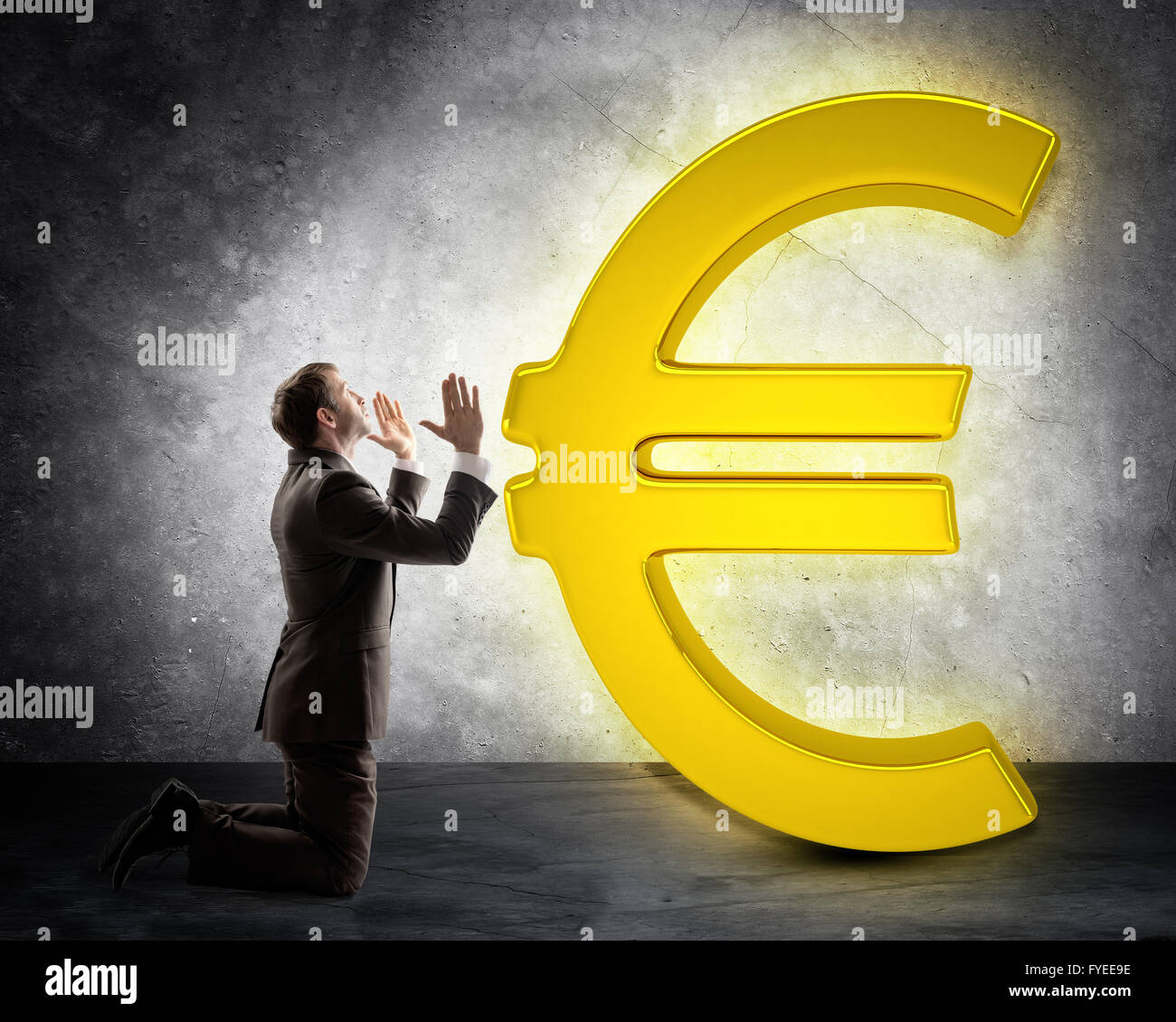 Businessman on knees in front of euro sign Stock Photo - Alamy