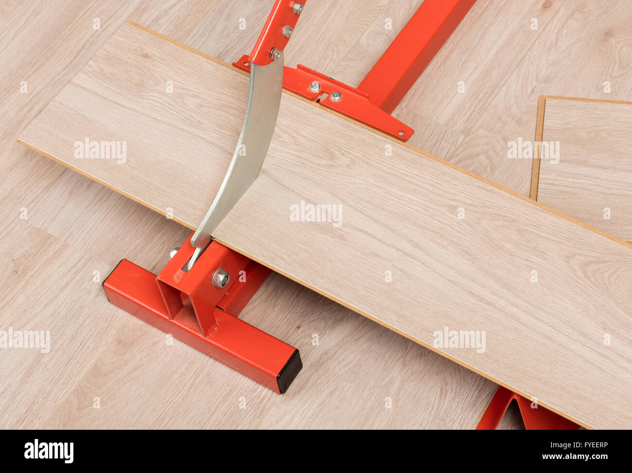 Red tool for cutting laminate on a laminate floor Stock Photo - Alamy