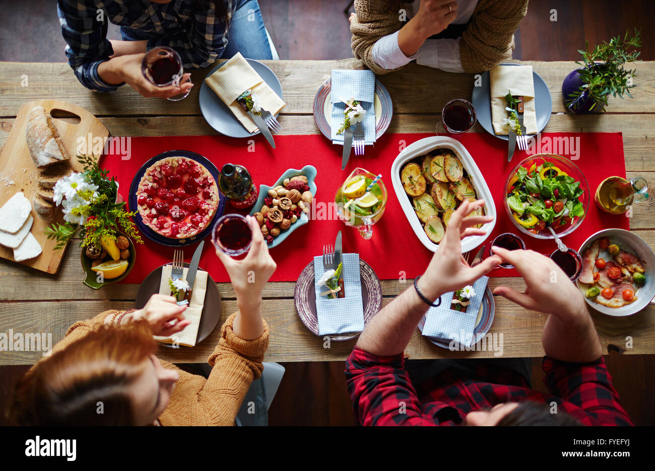 Eating by table Stock Photo - Alamy