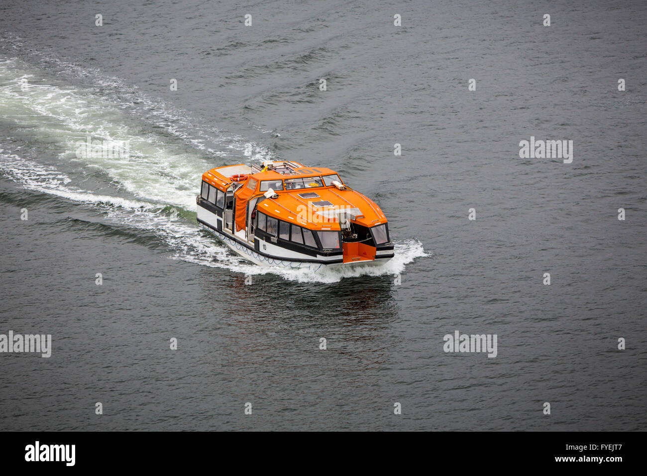 A tender boat from the cruise ship Zaandam off the village of Castro ...