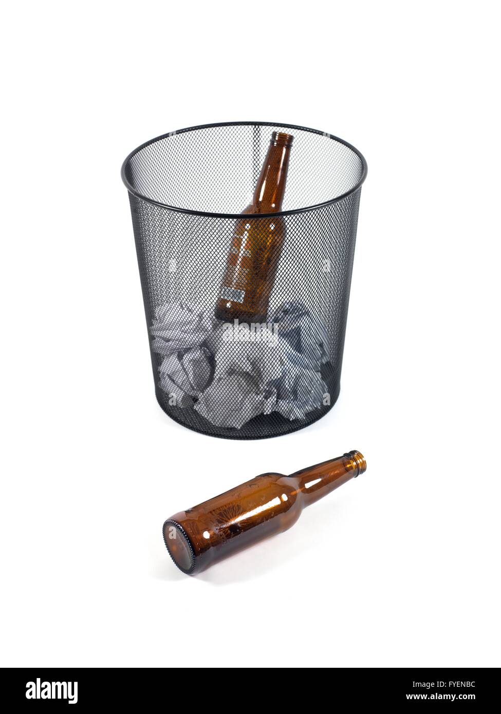 Bottles of beer in a trash can isolated against a white background ...
