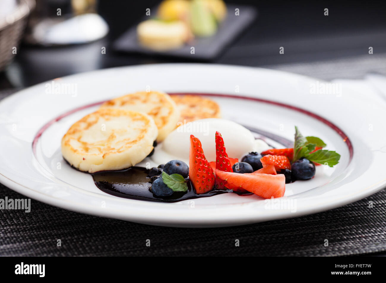 Syrniki with blueberry jam Stock Photo - Alamy