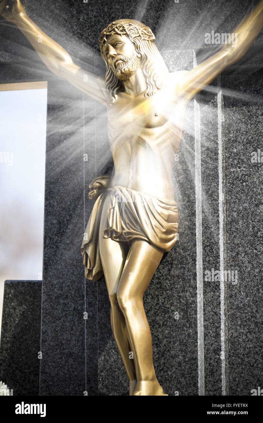 Jesus Christ on stone cross with mystic rays of light Stock Photo - Alamy