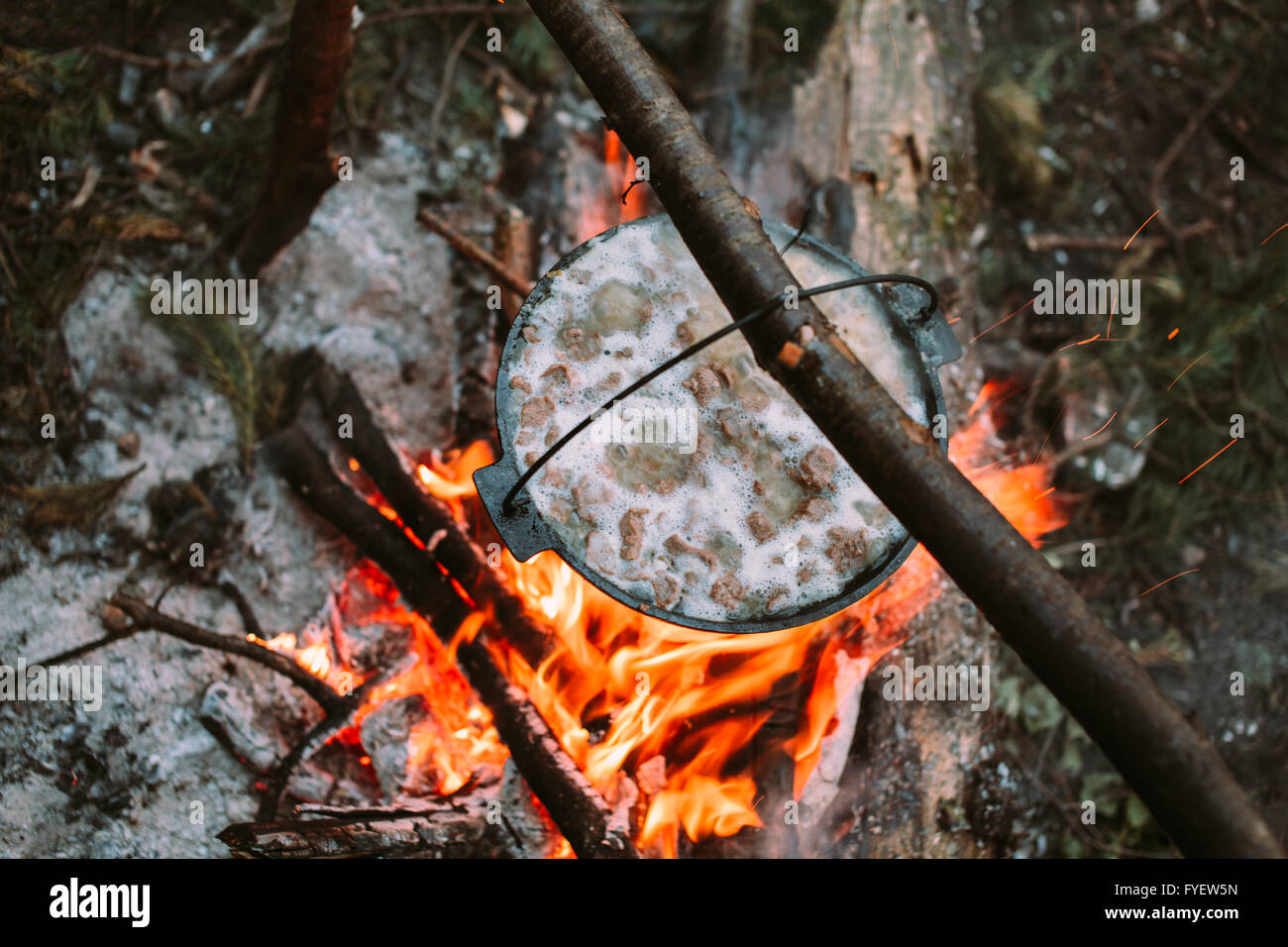 Fish soup to cook on fire in nature Stock Photo - Alamy