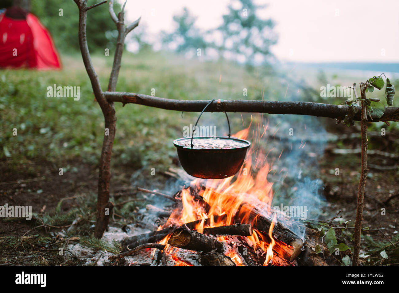 Fish soup to cook on fire in nature Stock Photo - Alamy