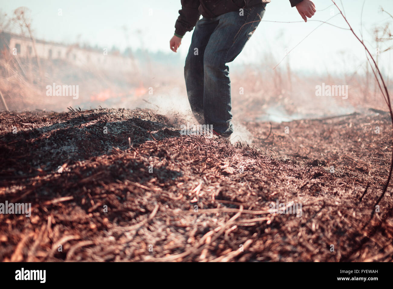 Legs of the person extinguish fire Stock Photo - Alamy