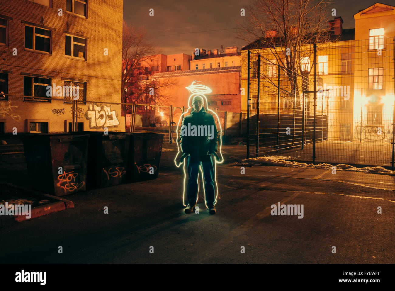 People circled the glowing wire at night in the courtyard Stock Photo ...