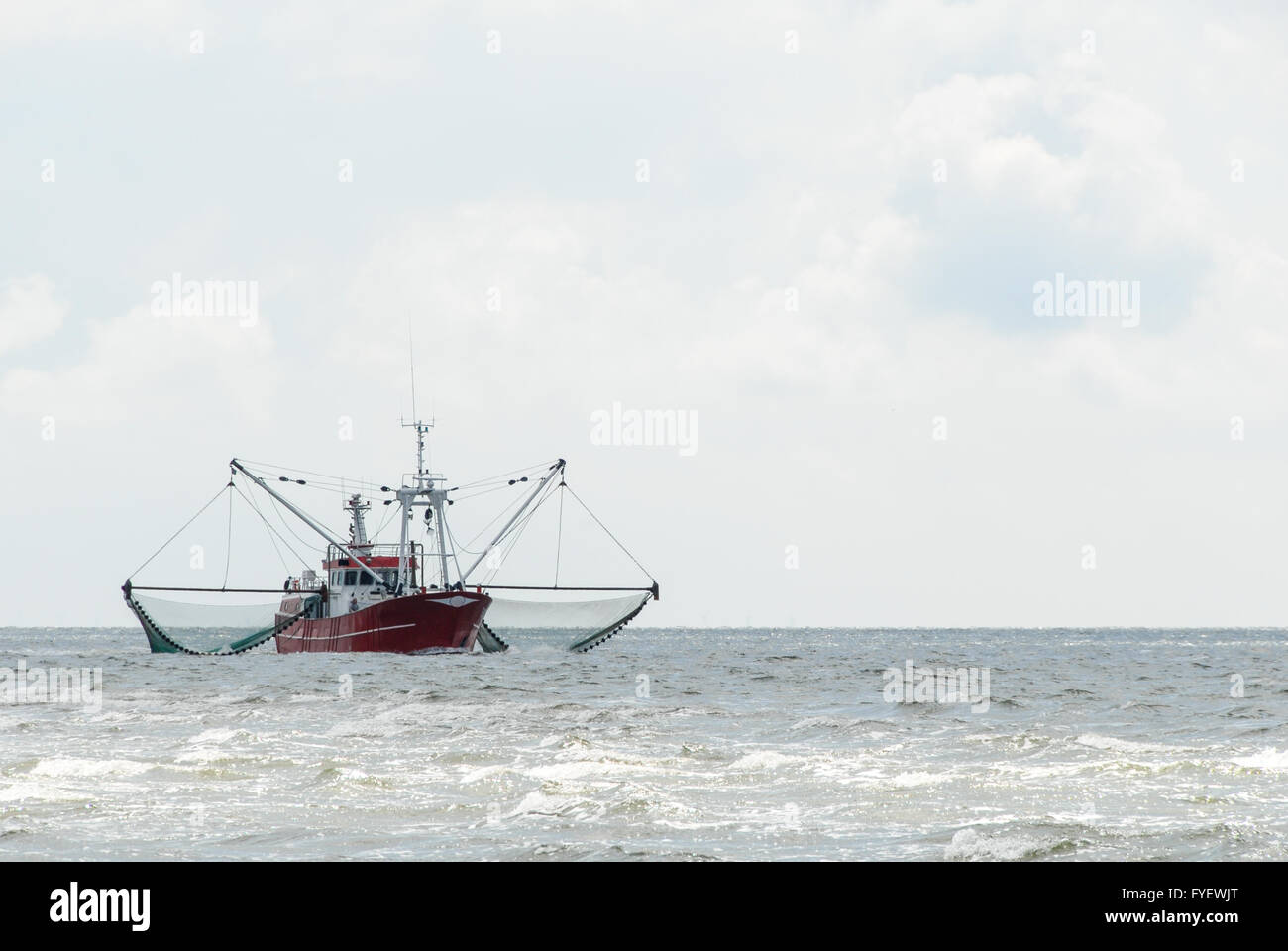 A fishing trawler pulls the trawls near the Danish island of Romo Stock ...