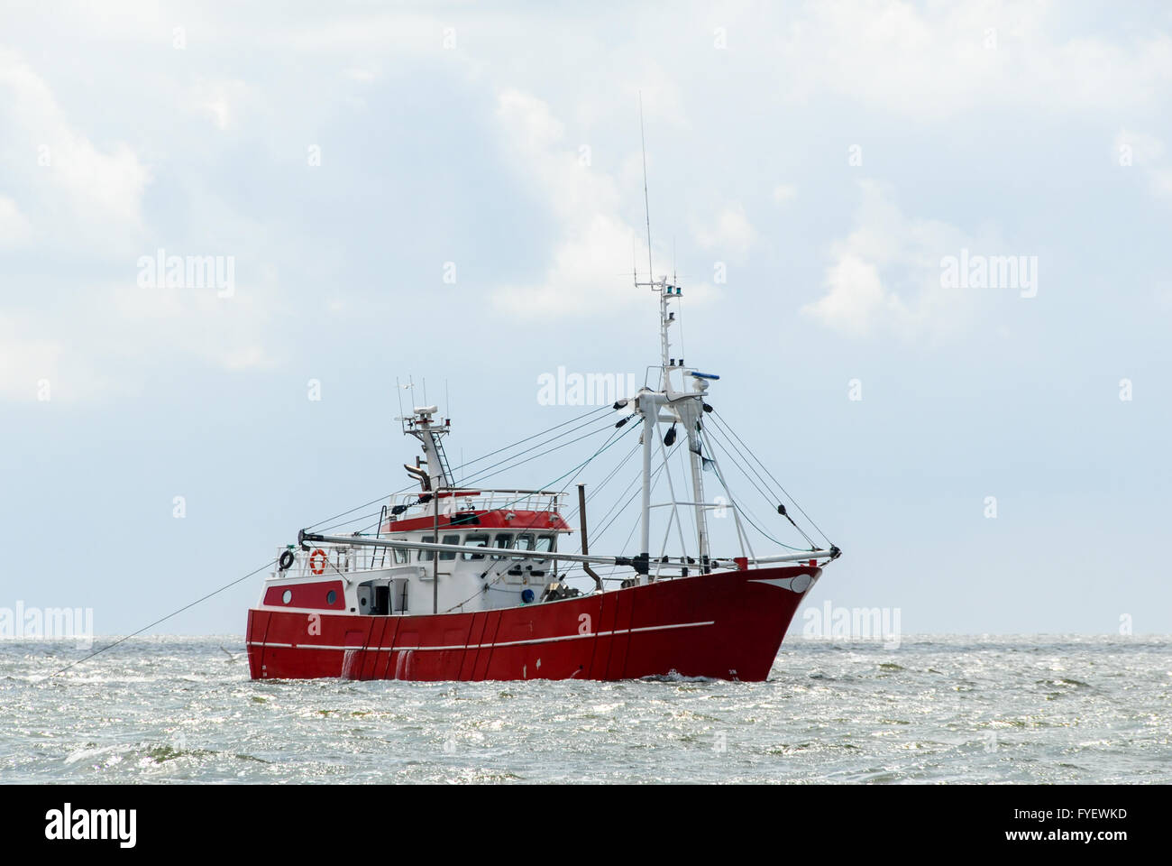 A fishing trawler pulls the trawls near the Danish island of Romo Stock ...