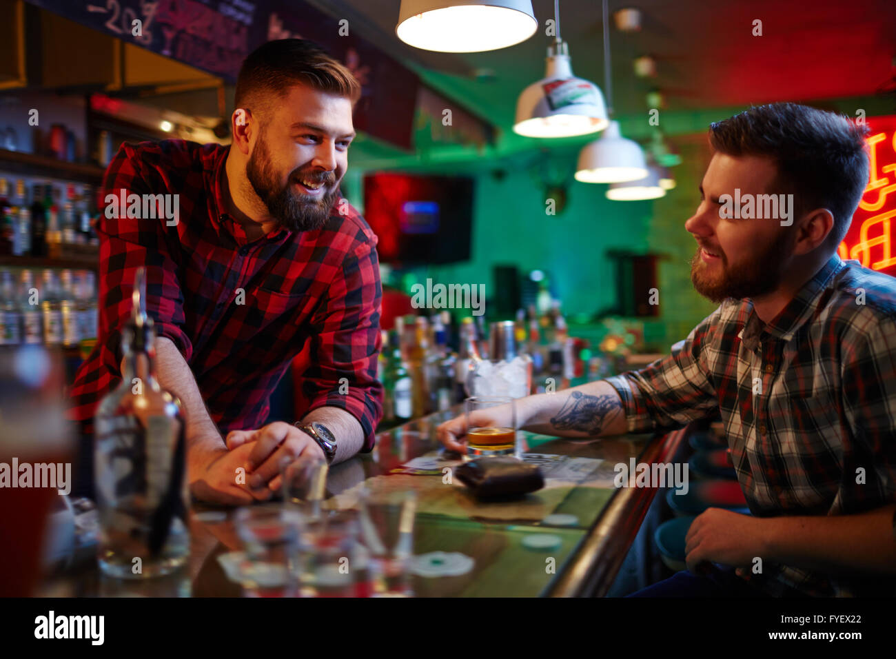 Young people talking bar counter hi-res stock photography and images ...
