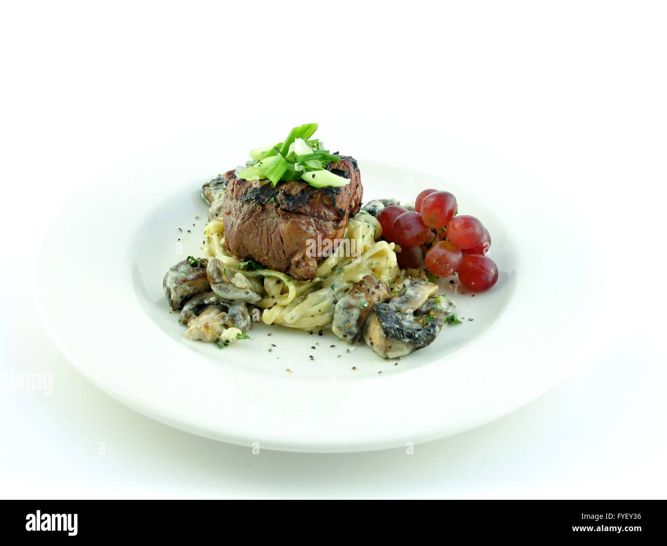 Filet mignon over pasta Stock Photo - Alamy