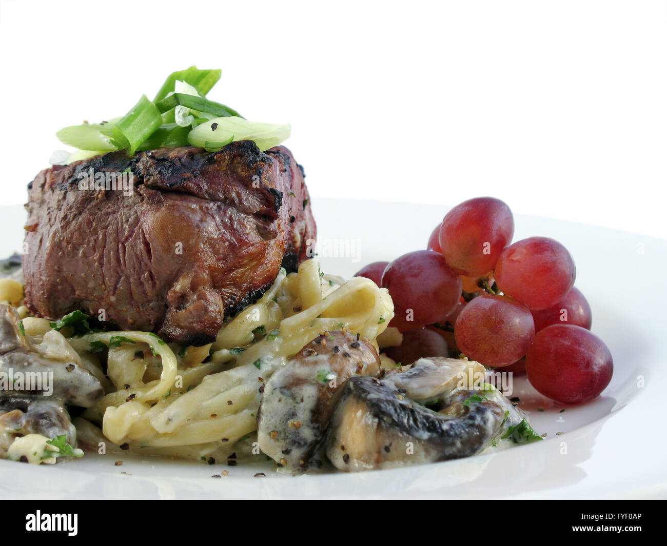 Filet mignon over pasta Stock Photo - Alamy