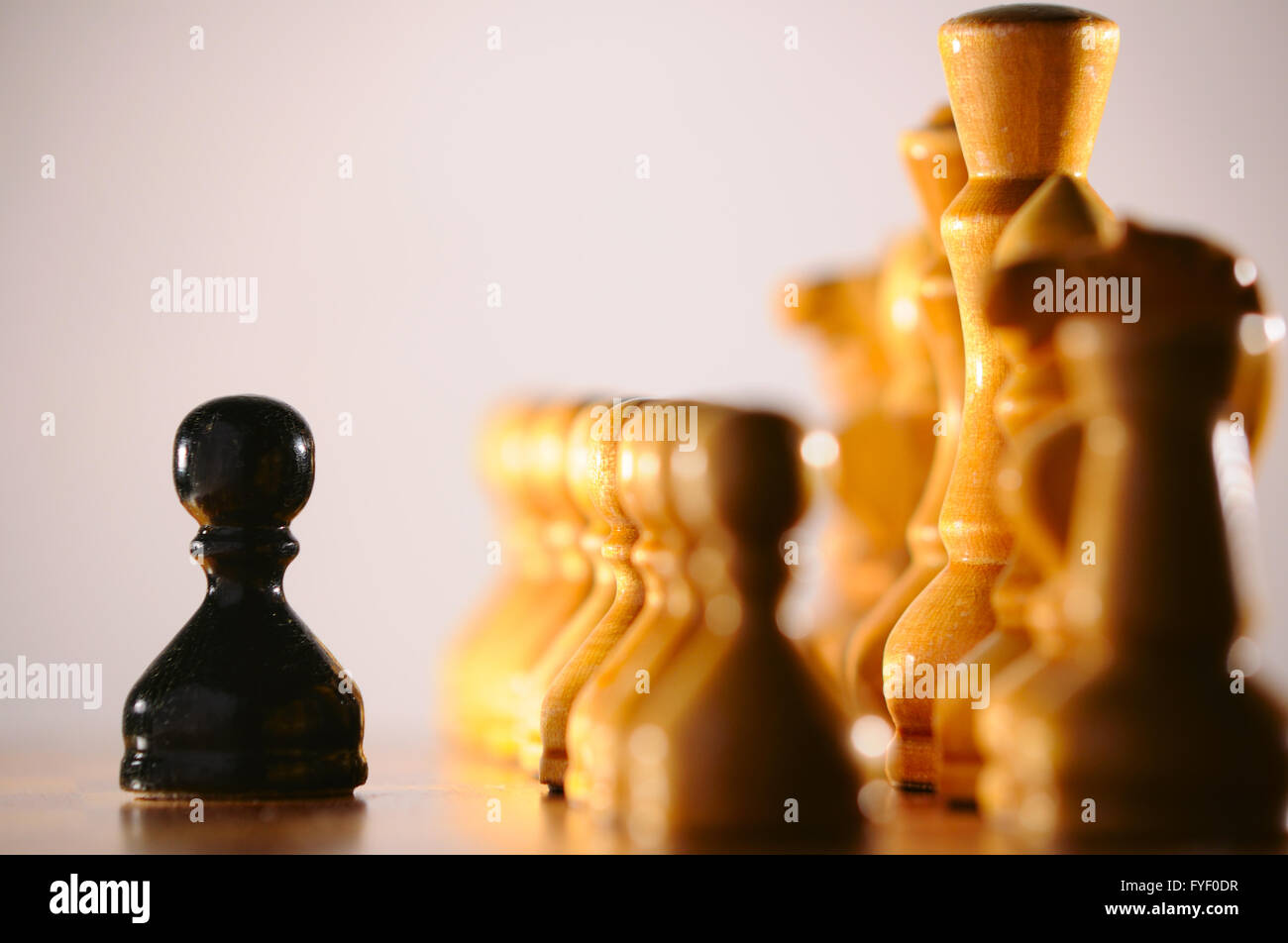 black pawn against white chess pieces army Stock Photo - Alamy