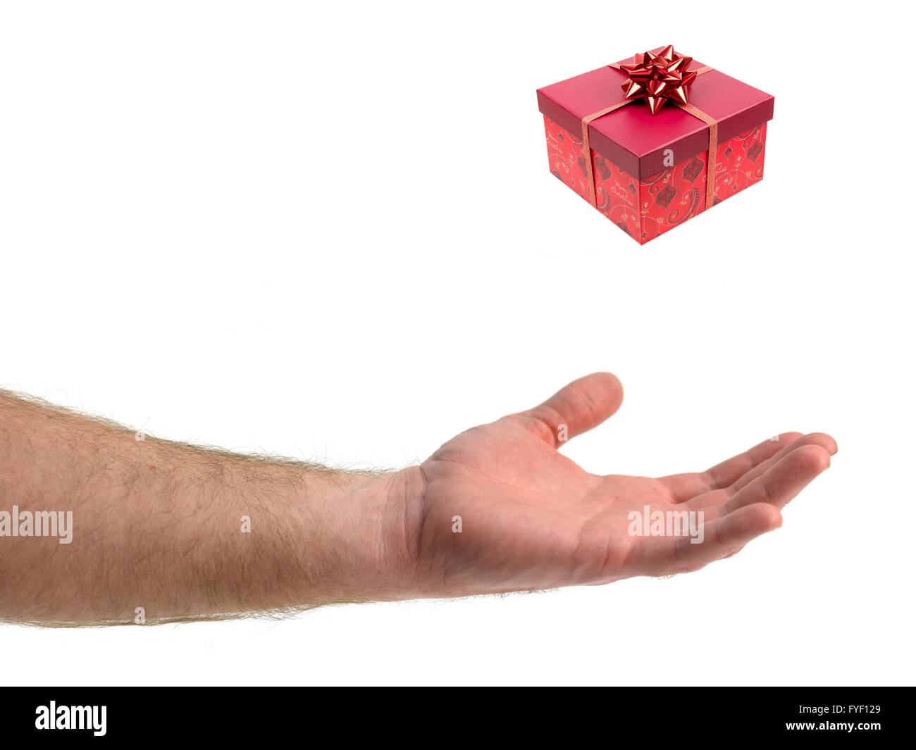 A hand catching a christmas present isolated against a white background ...