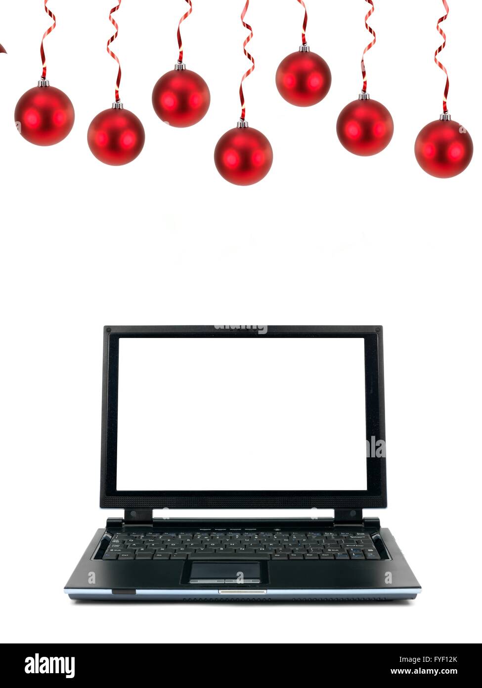 A laptop computer with christmas ornaments isolated against a white ...
