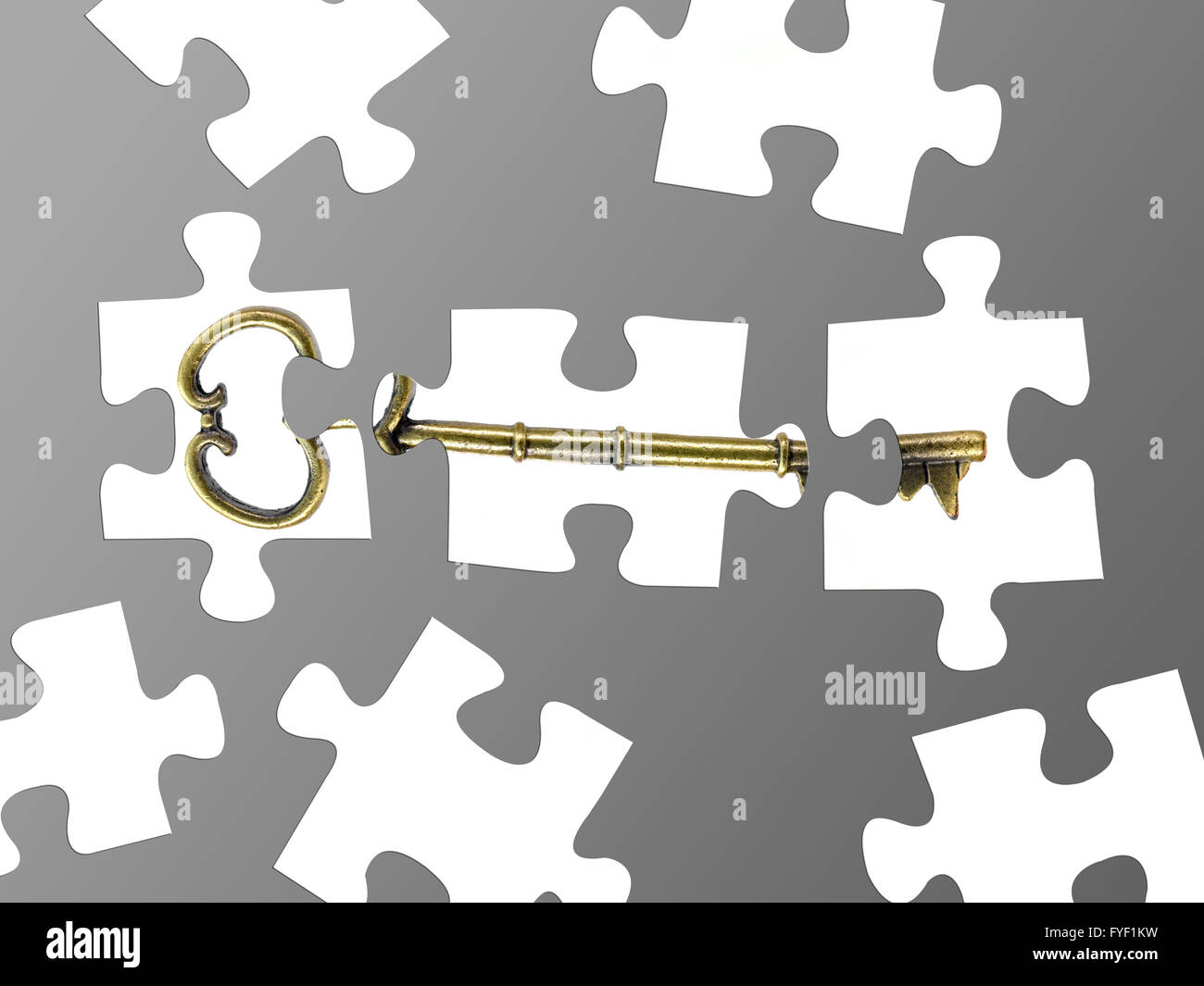 Jigsaw puzzle pieces of a key isolated against a grey background Stock ...