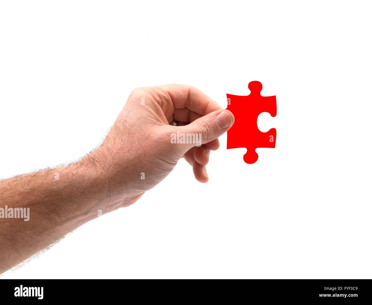 A hand holding a jigsaw piece isolated against a white background Stock ...