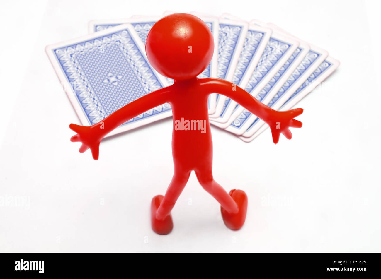 Playing cards and red human figure Stock Photo - Alamy