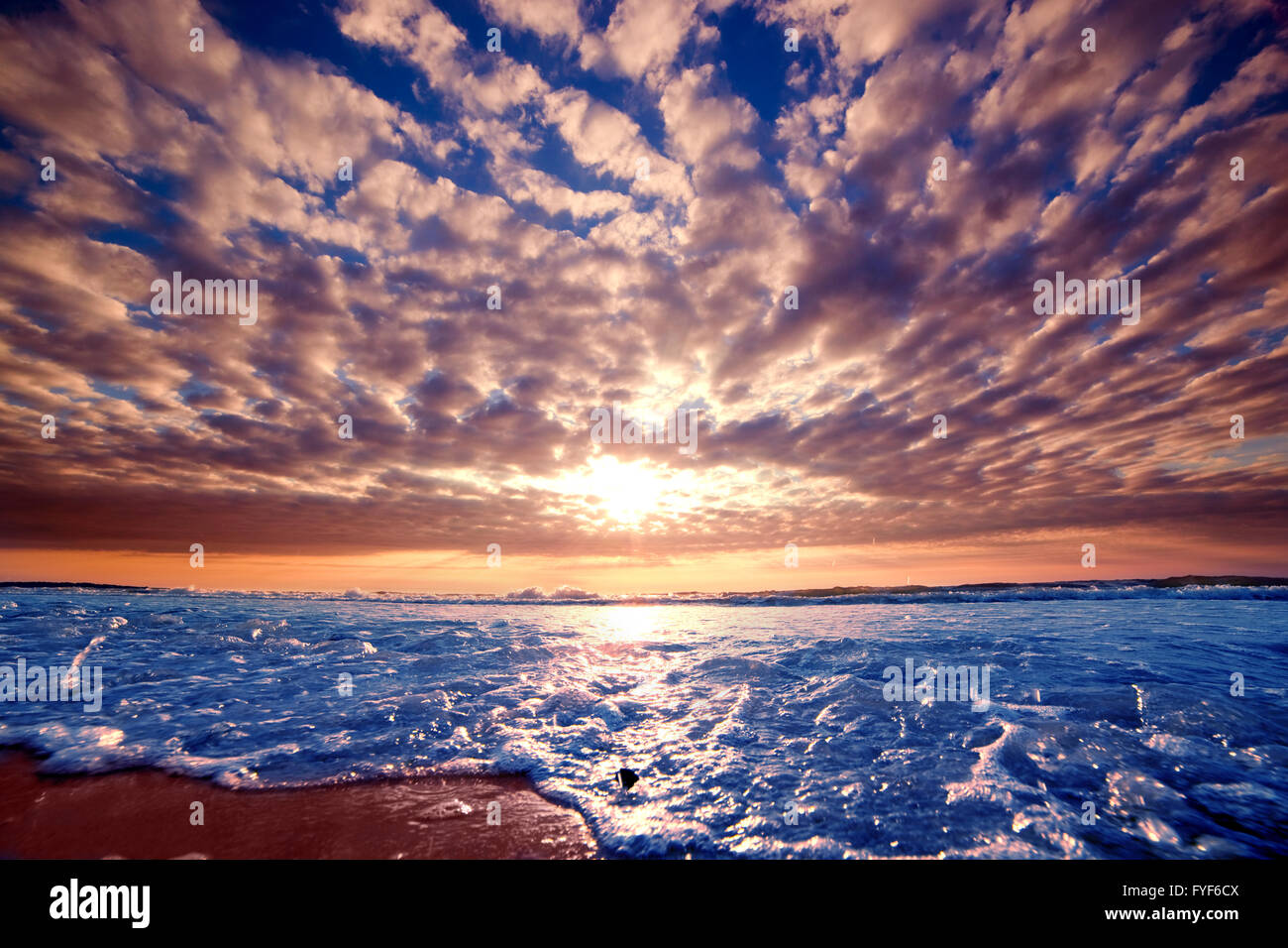 Romantic sunrise over ocean. Dramatic sky Stock Photo - Alamy