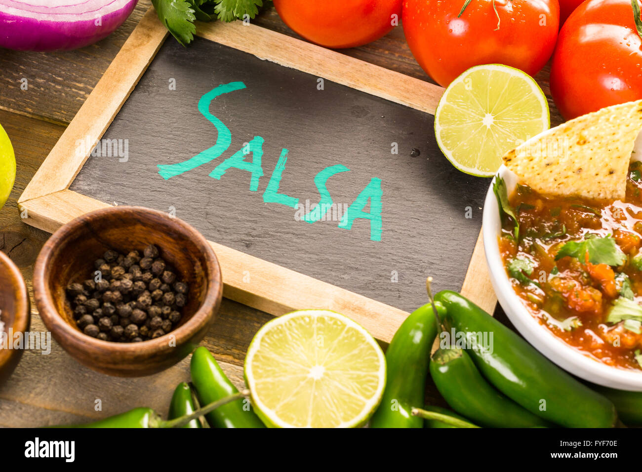 Fresh salsa in white bowl with ingredients Stock Photo - Alamy