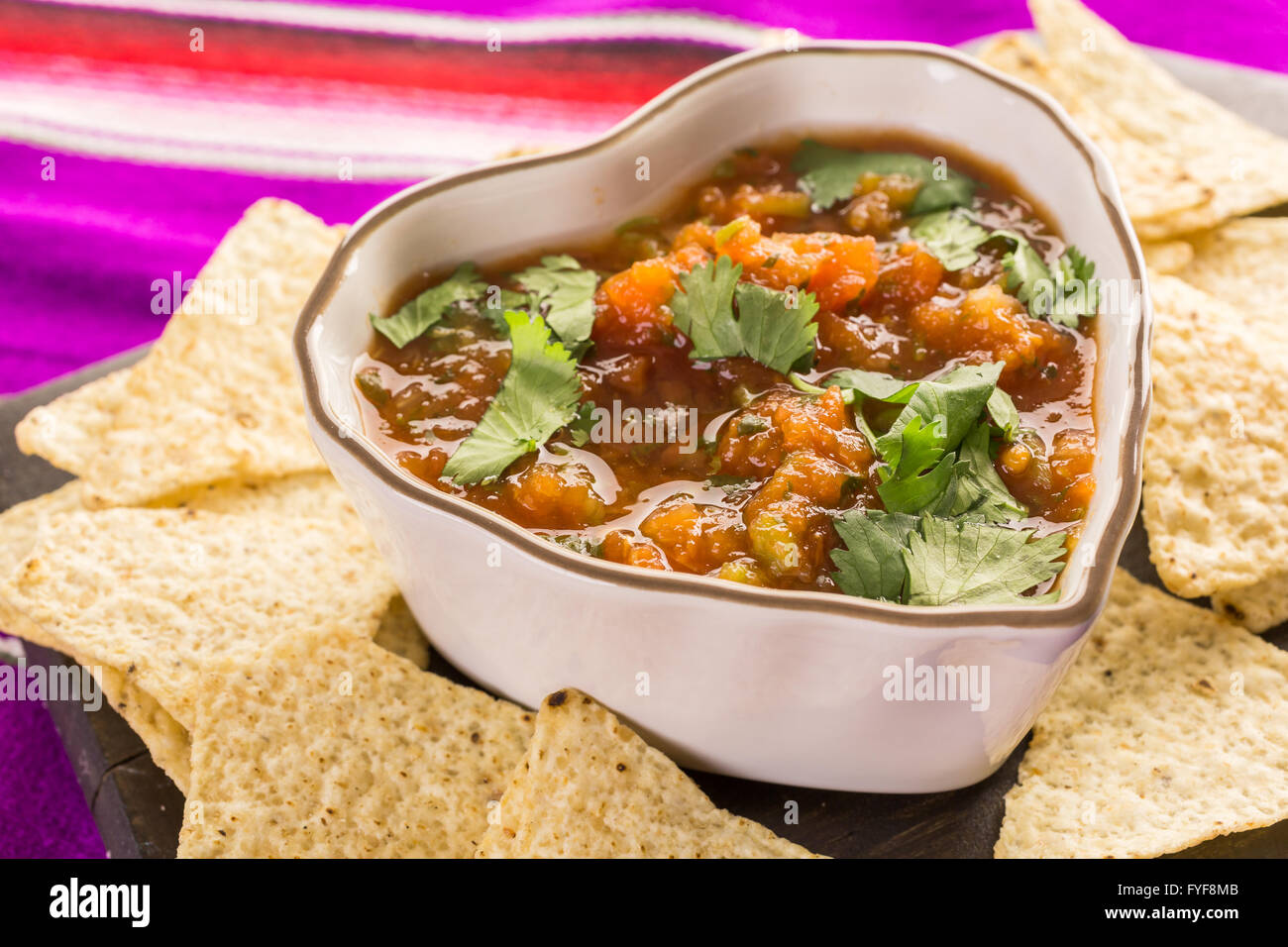 Fresh salsa in white bowl with white corn tortilla chips Stock Photo ...