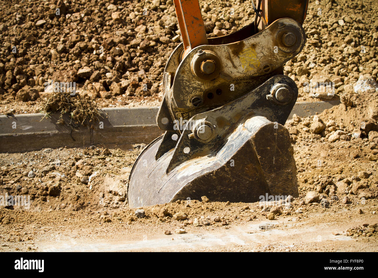 Excavator digging a deep trench Stock Photo - Alamy