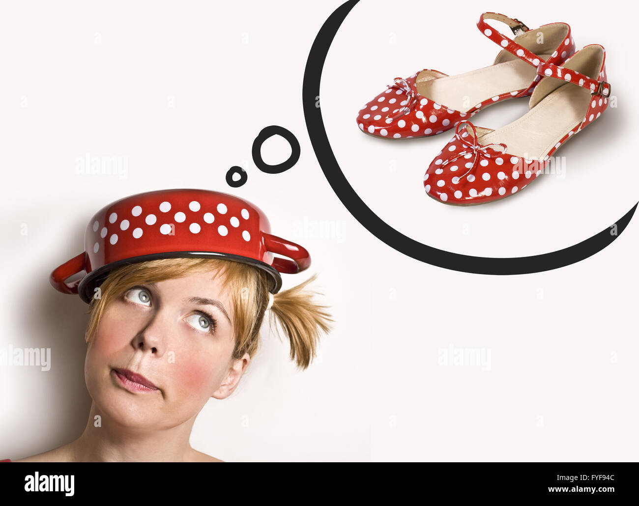 A beautiful young blonde woman with a small red dotted pan on her head ...
