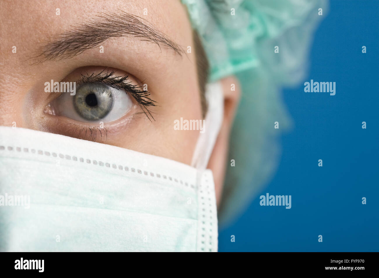 Horizontal portrait of a blue eyed nurse with white surgical mask Stock ...