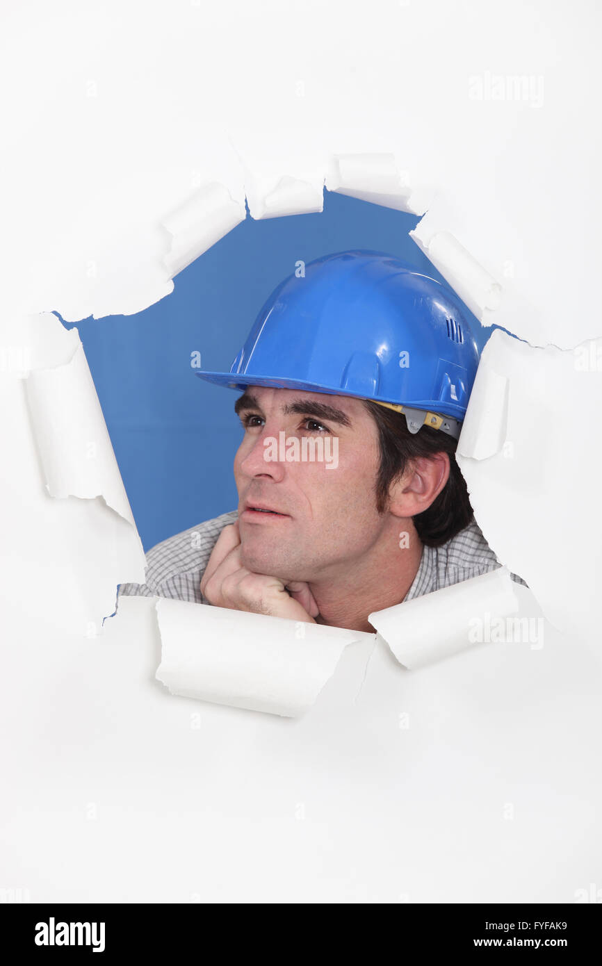 Man looking through hole in wall hi-res stock photography and images ...