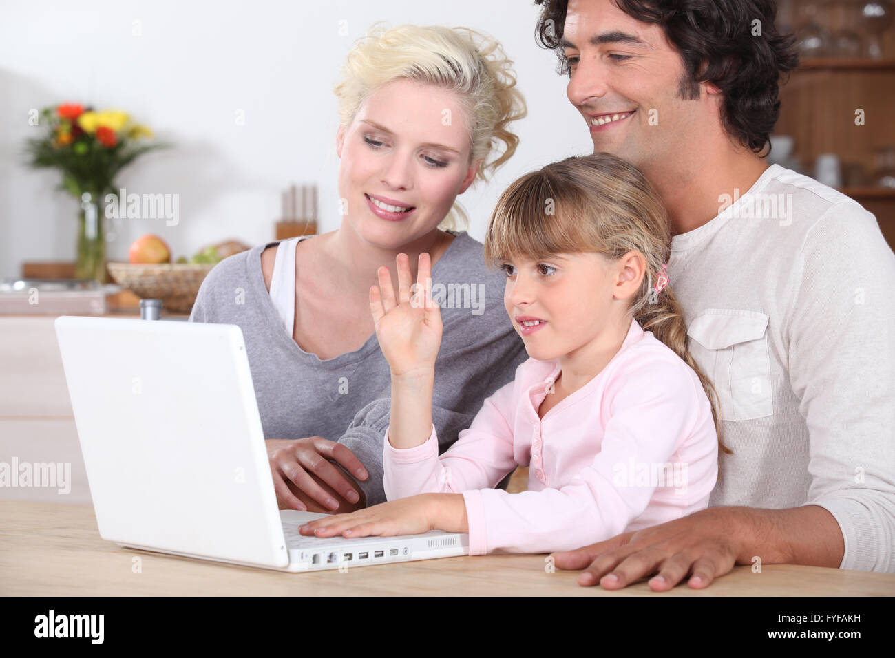 parents and their little girl having fun on the Internet Stock Photo ...