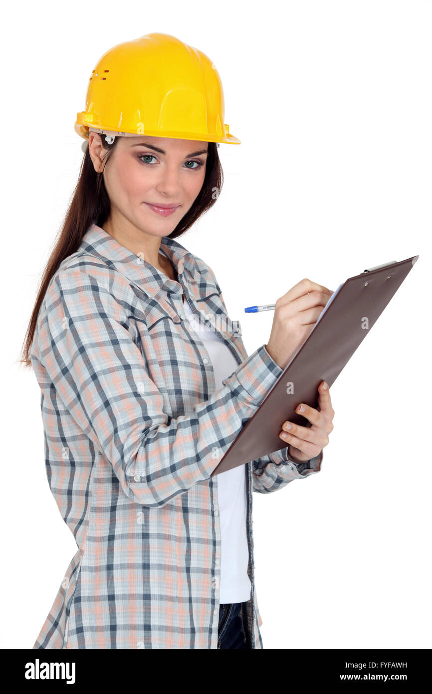 Female construction worker writing on her clipboard Stock Photo - Alamy