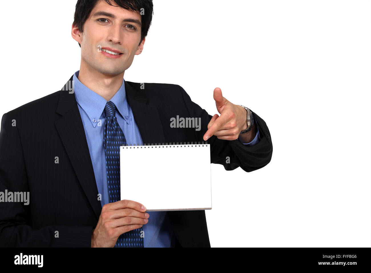 handsome young businessman pointing at spiral notebook Stock Photo - Alamy