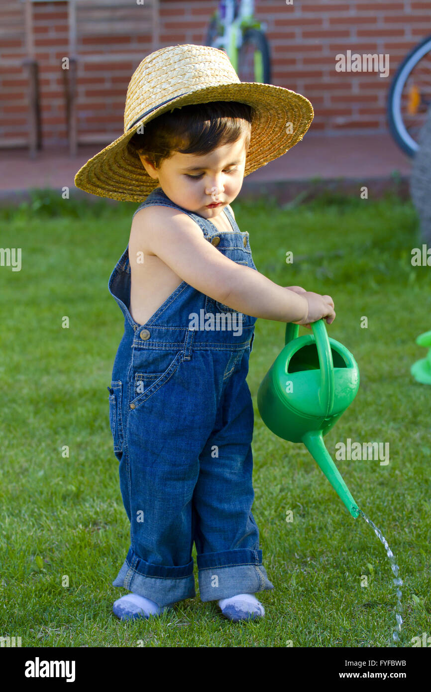 little baby boy gardener playing in his front yard Stock Photo - Alamy
